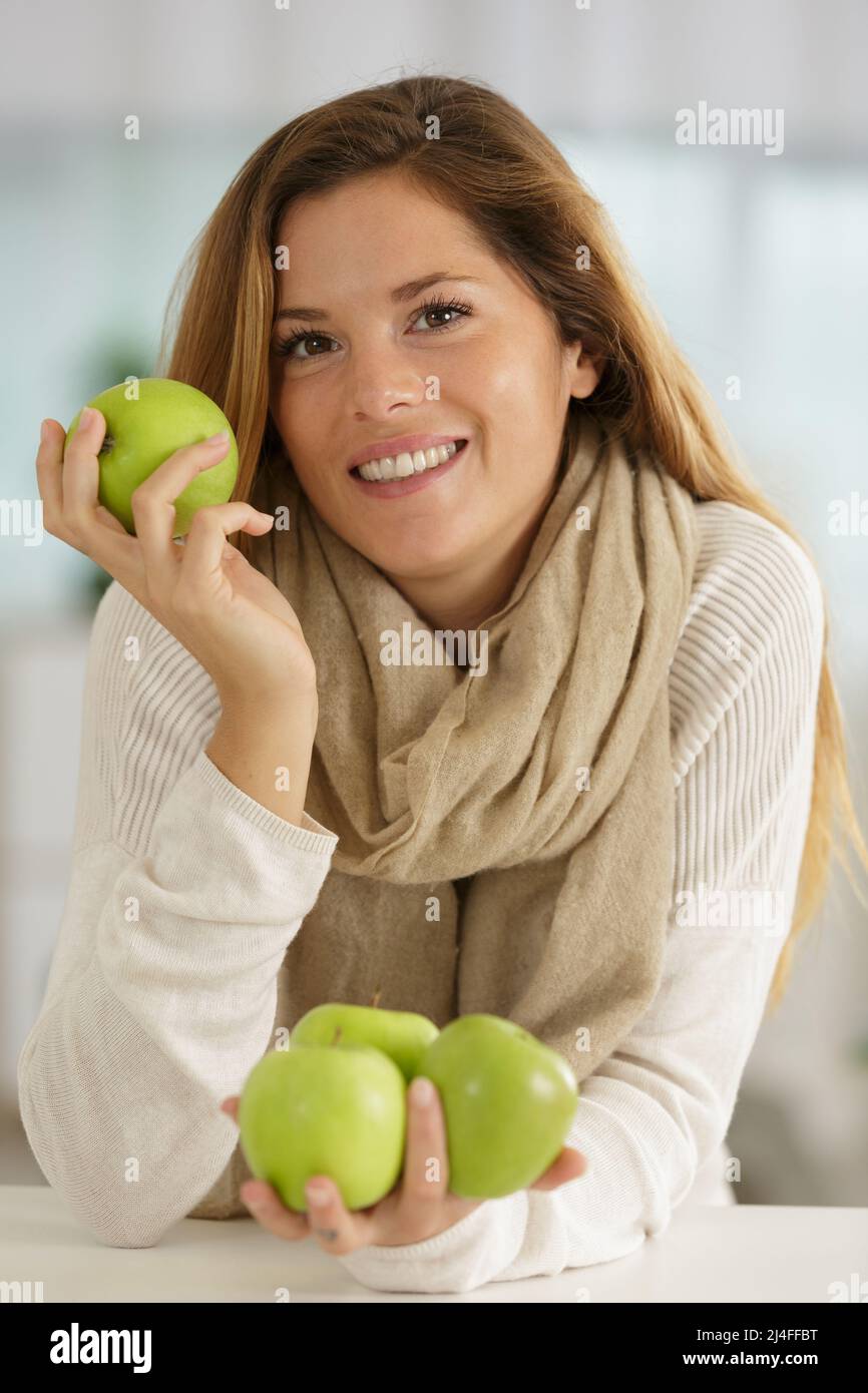 a woman is eating an apple Stock Photo - Alamy