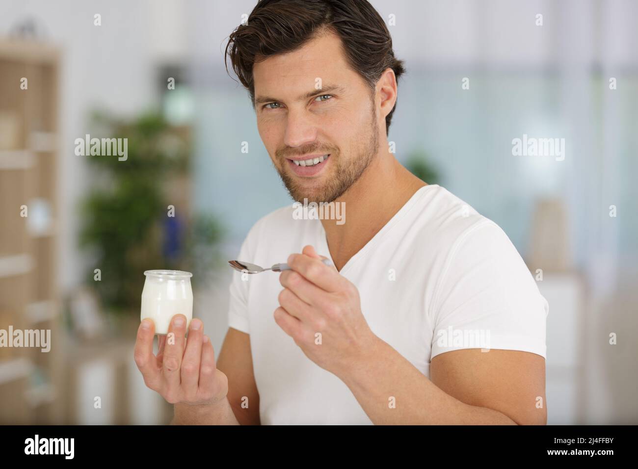 handsome man eating natural yogurt Stock Photo - Alamy handsome man eating natural yogurt Stock Photo - Alamy