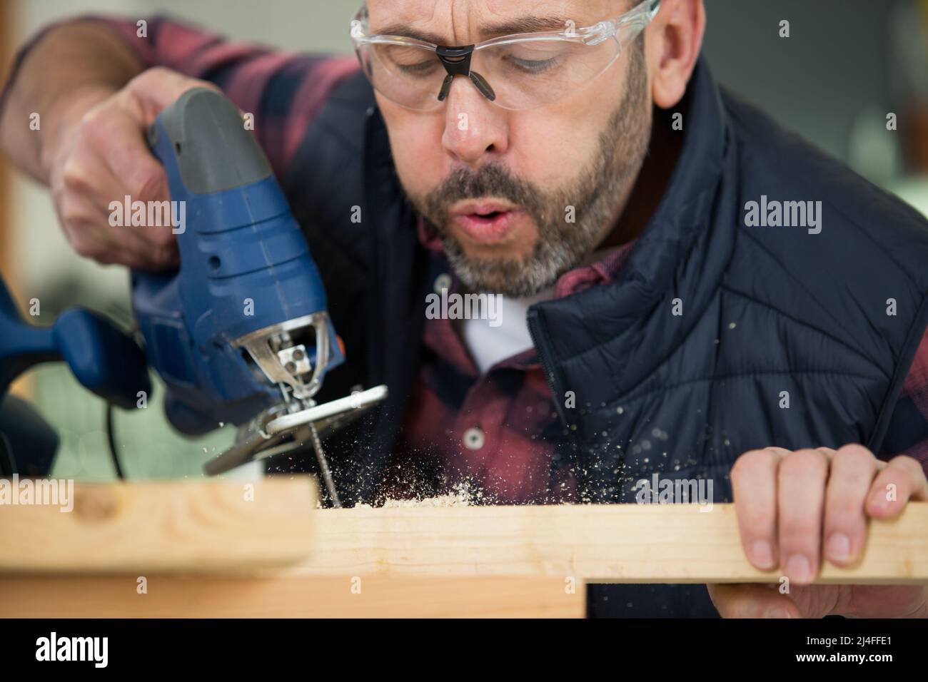 Focused carpenter sawing wood hi-res stock photography and images - Alamy
