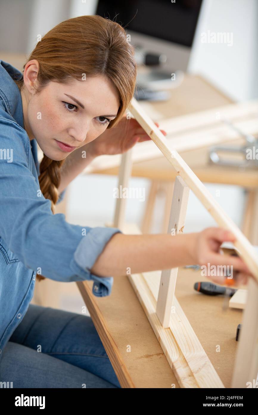 woman putting together self assembly furniture Stock Photo - Alamy