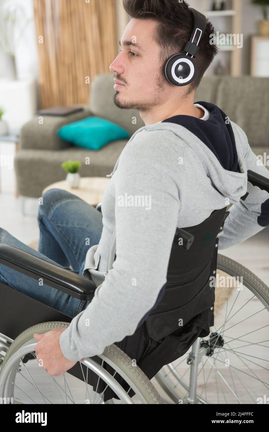 handicapped man listens to music in headphones Stock Photo - Alamy