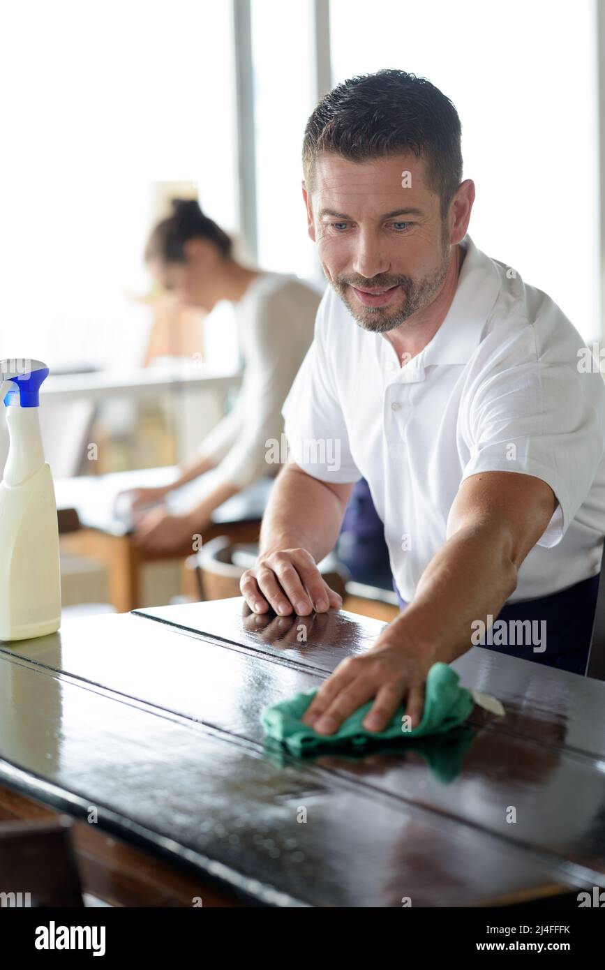 portrait of happy bar tender cleaning bar counter Stock Photo - Alamy
