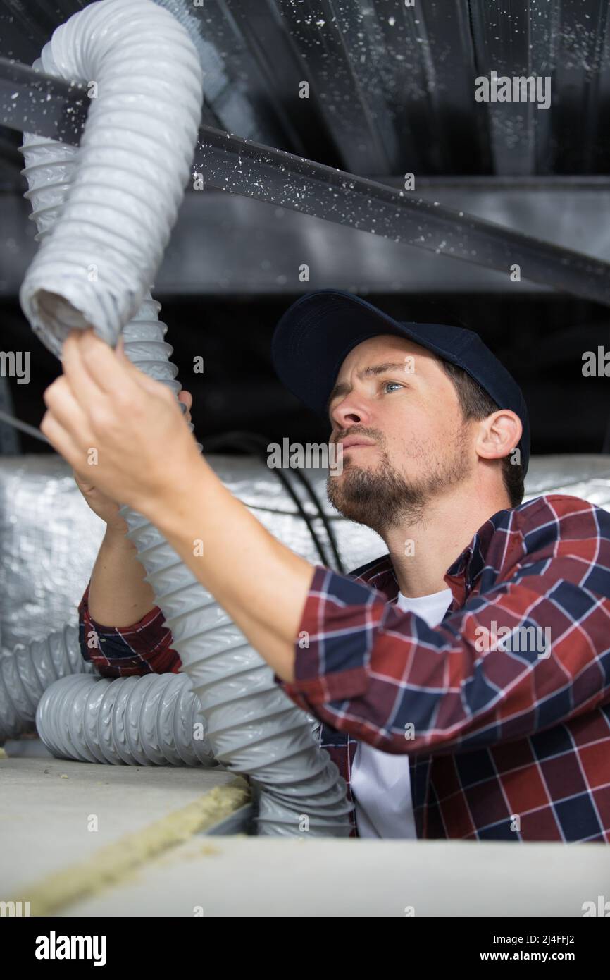 young male worker fixing a tube Stock Photo - Alamy