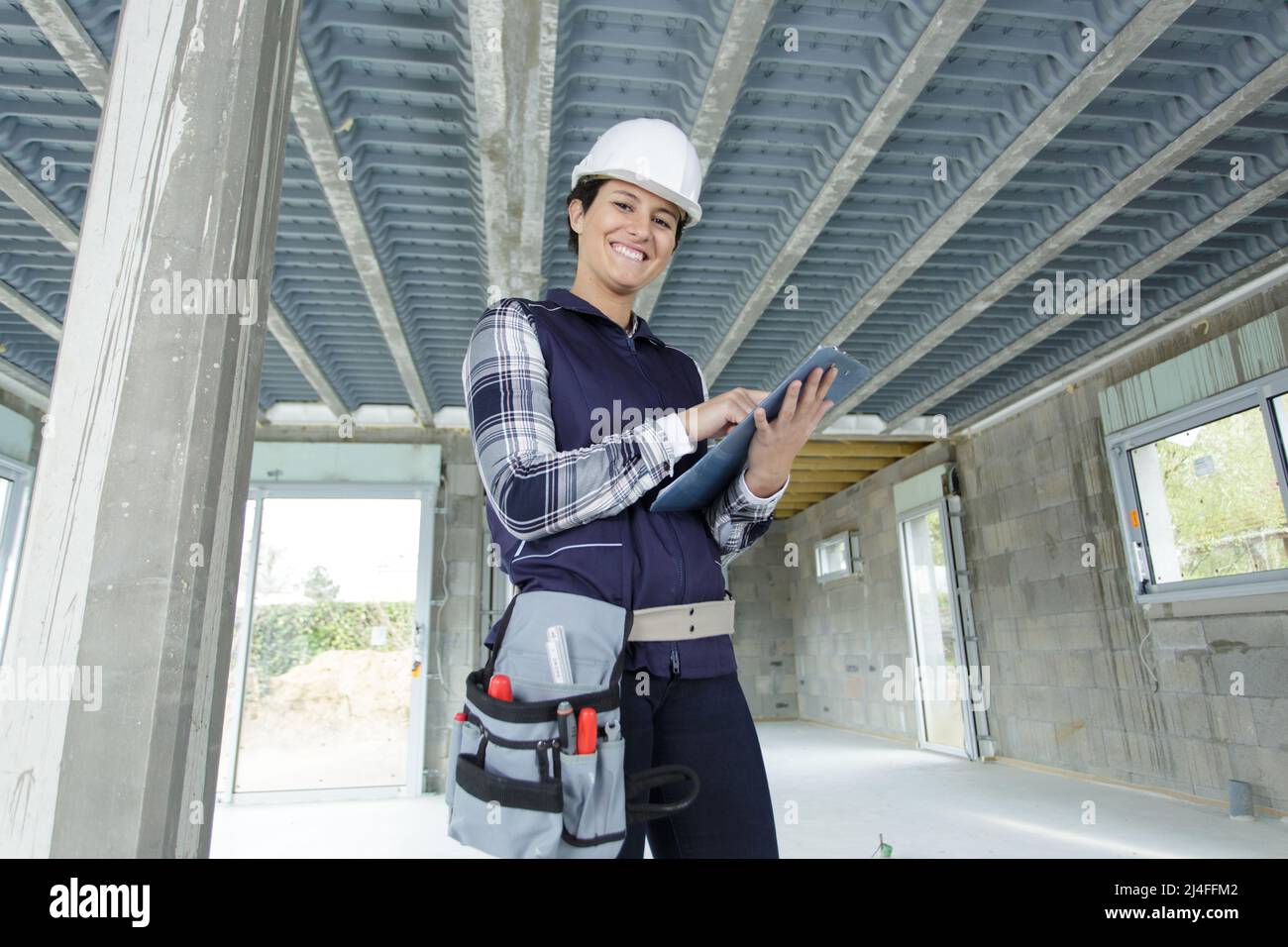 engineer holding a clipboard in a construction site Stock Photo - Alamy