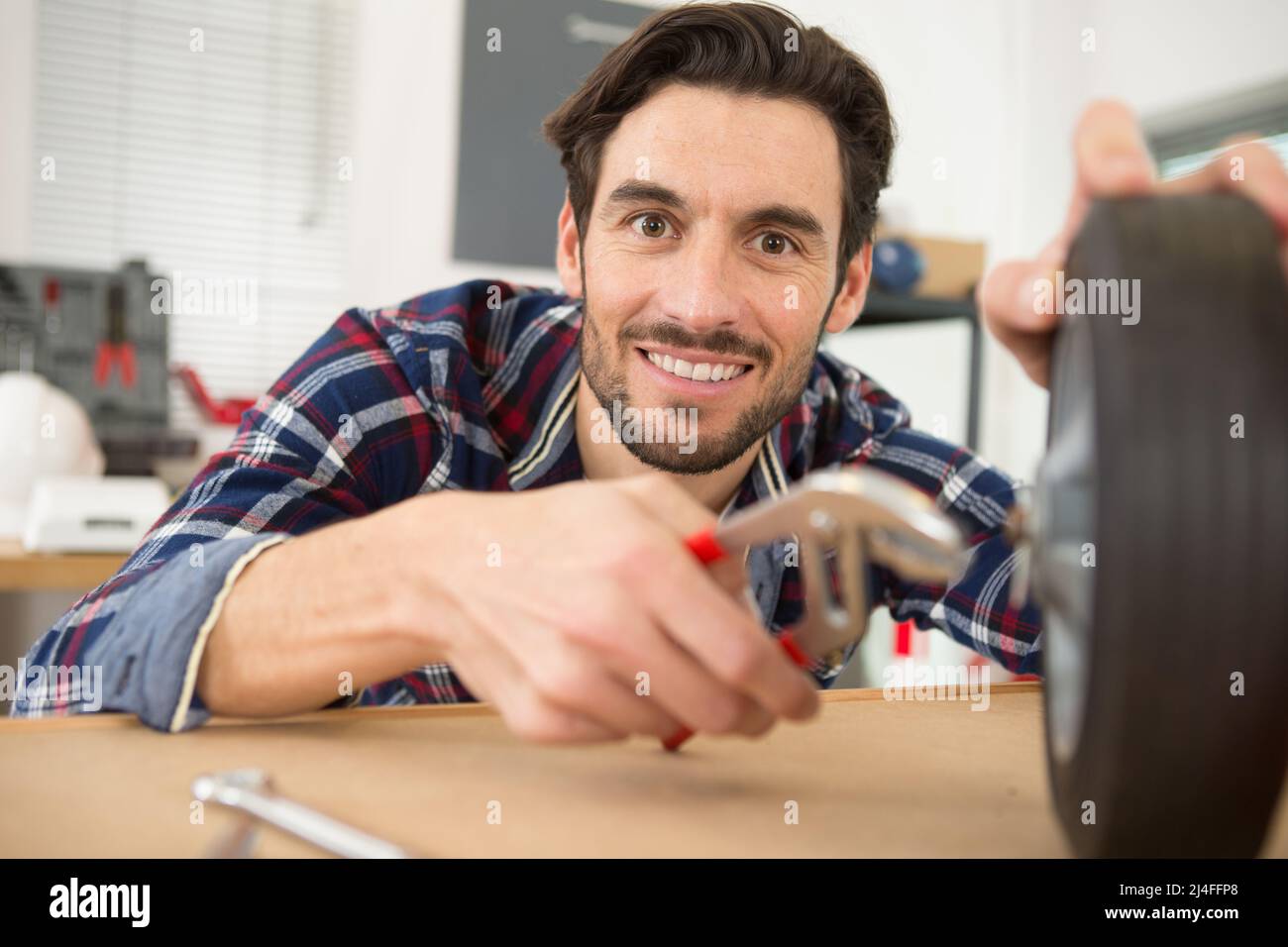 engineer repairing wheel on a sack truck Stock Photo - Alamy