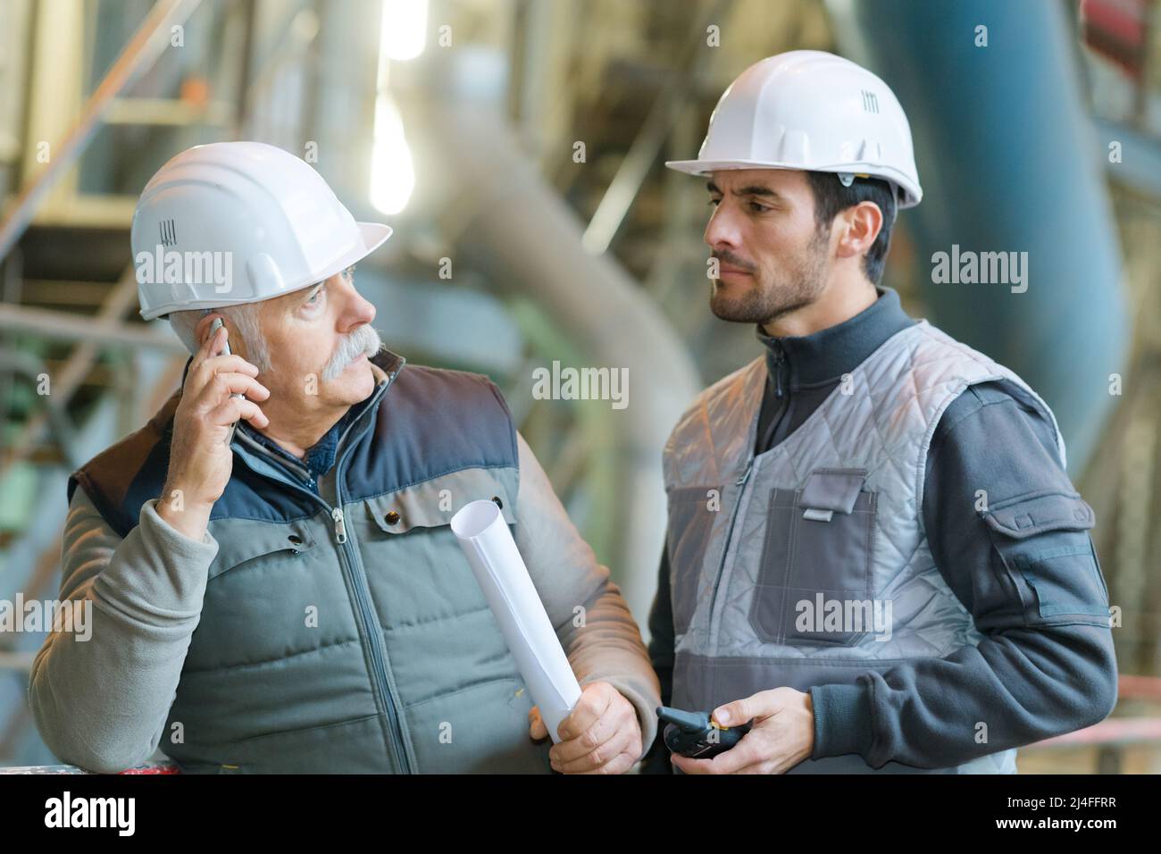 Standing communication listening hands in pockets hi-res stock ...