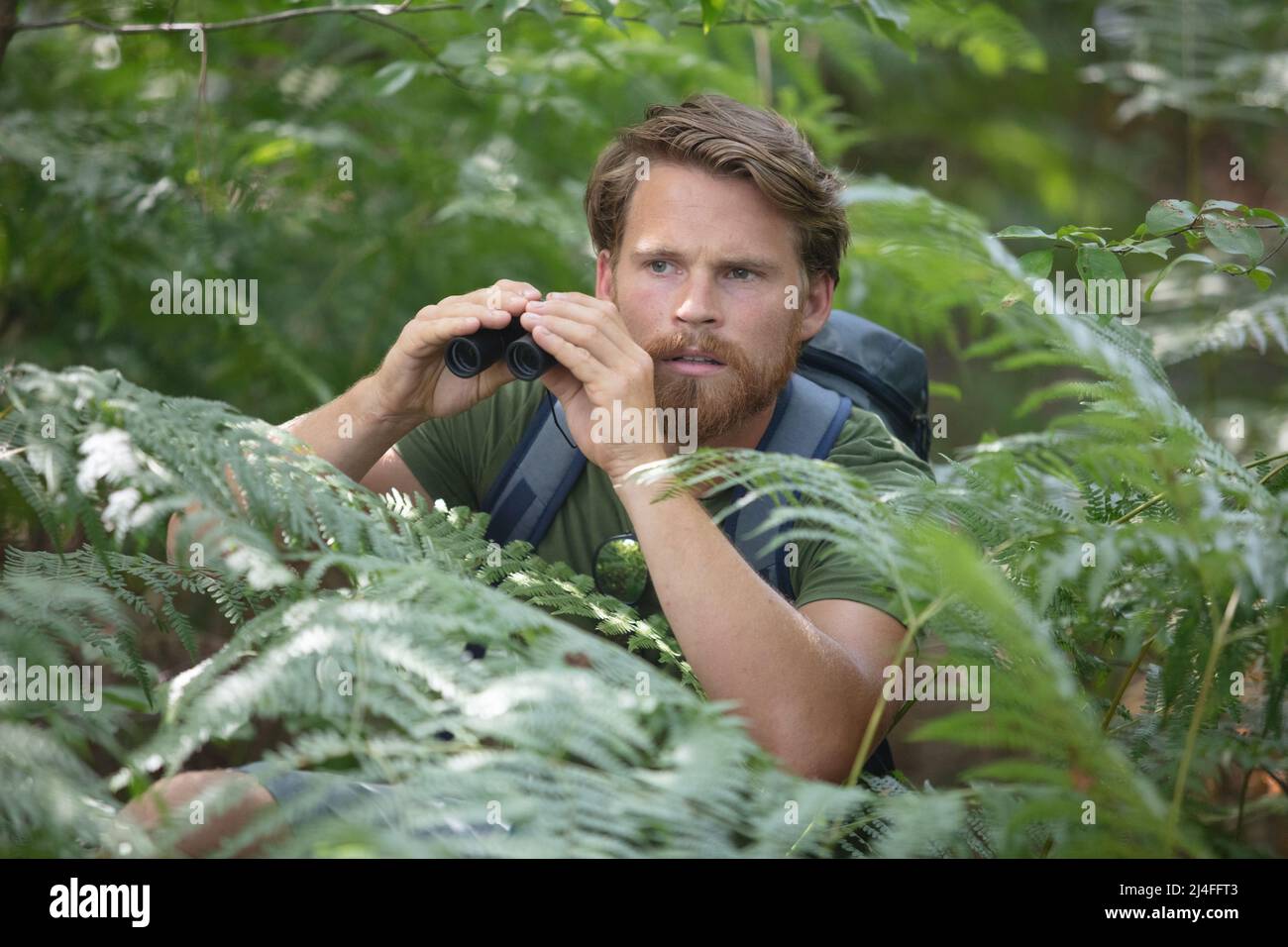 handsome scared and shocked traveler with binoculars Stock Photo - Alamy