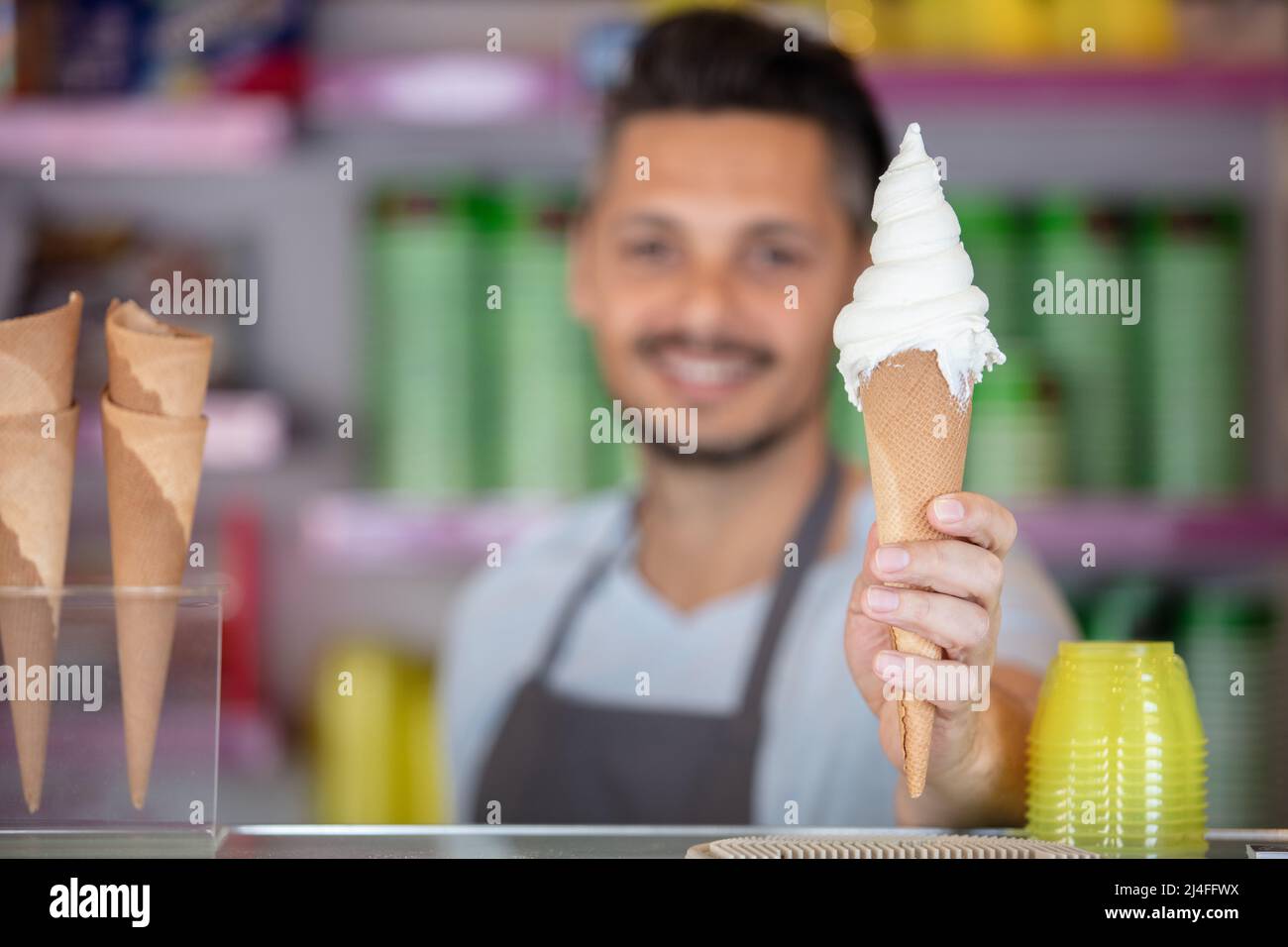 male ice-cream vendor serving a cone Stock Photo - Alamy