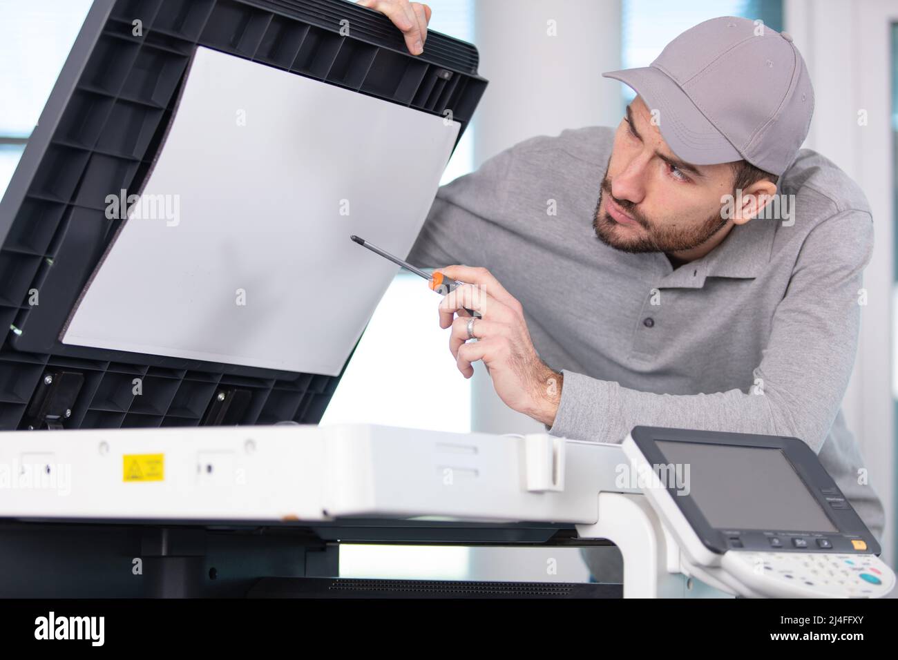 man technician repairing a printer at business place at work Stock ...