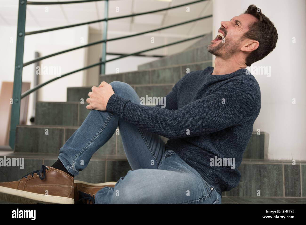 man suffering after falling from stairs Stock Photo - Alamy