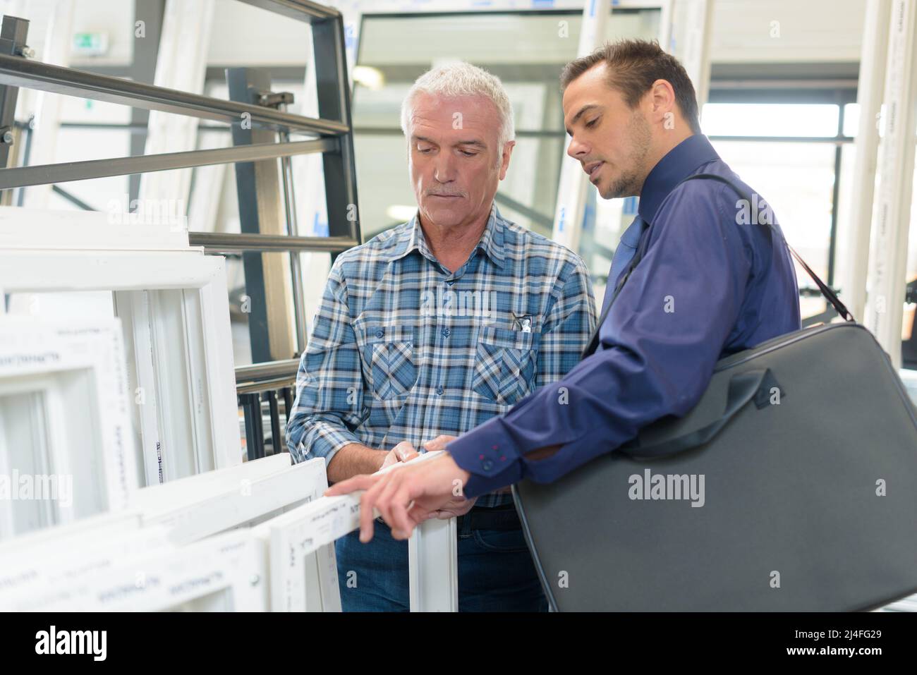 salesman with worker in double glazing premises Stock Photo - Alamy