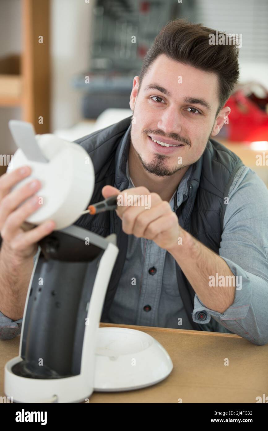 Repairman fixing coffee machine hi-res stock photography and images - Alamy