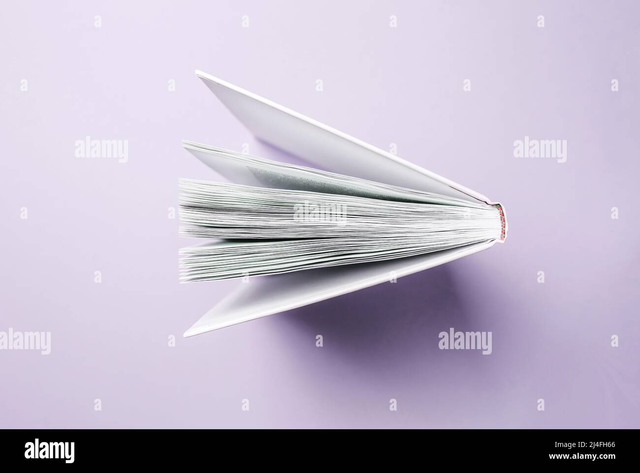 Open book on a purple background. Mock up with education and reading ...