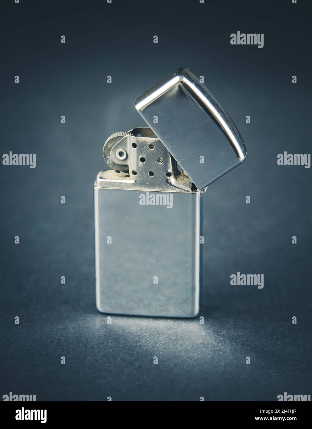 Old classic vintage lighter on a dark background Stock Photo - Alamy