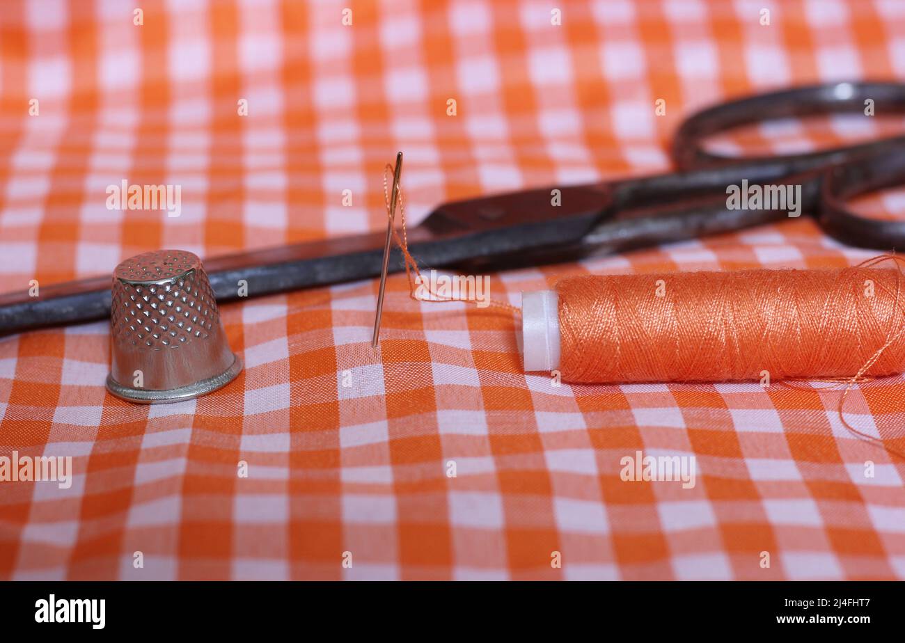 Orange and White Checkered Fabric With Thimble and Spool of Orange ...