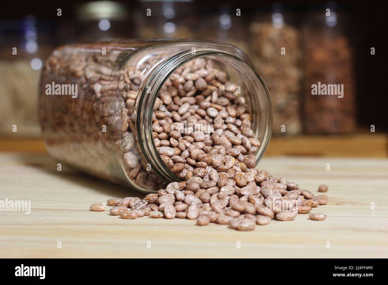Jar of Pinto Beans Spilled on Kitchen Table With Jars of Beans in ...