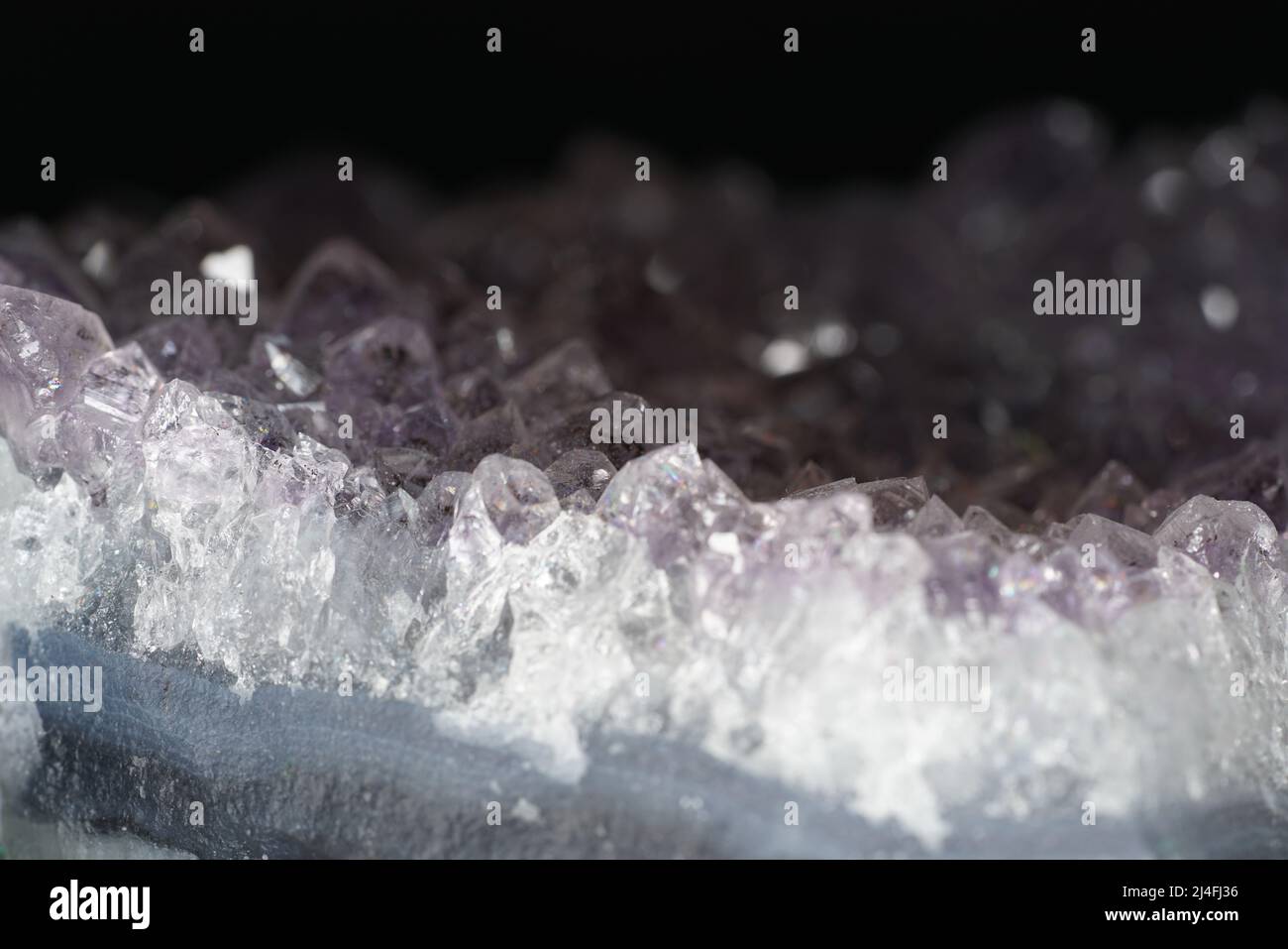 Quartz with mineral inclusions in the studio in front of a background ...