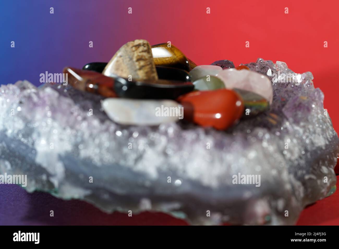 Quartz with mineral inclusions in the studio in front of a background ...
