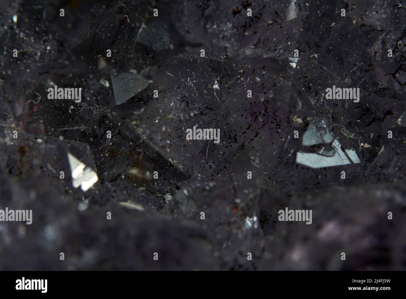 Quartz with mineral inclusions in the studio in front of a background ...