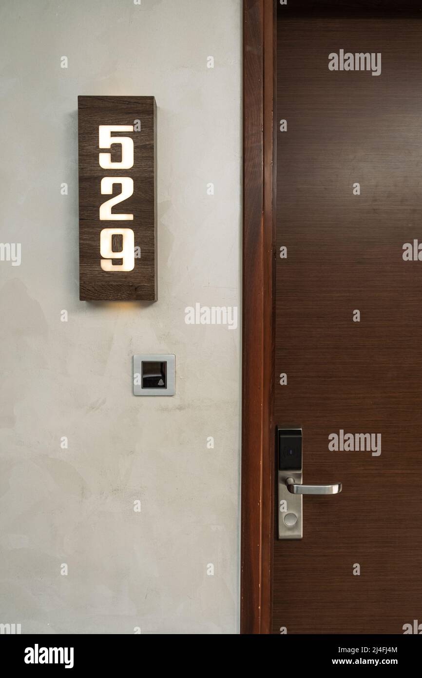 room number or name plate sign on the wooden wall for hotel or resort ...