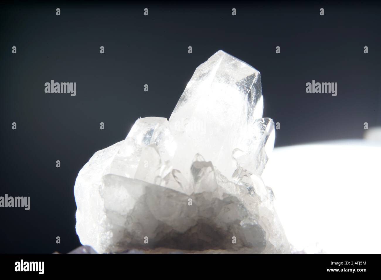Quartz with mineral inclusions in the studio in front of a background ...