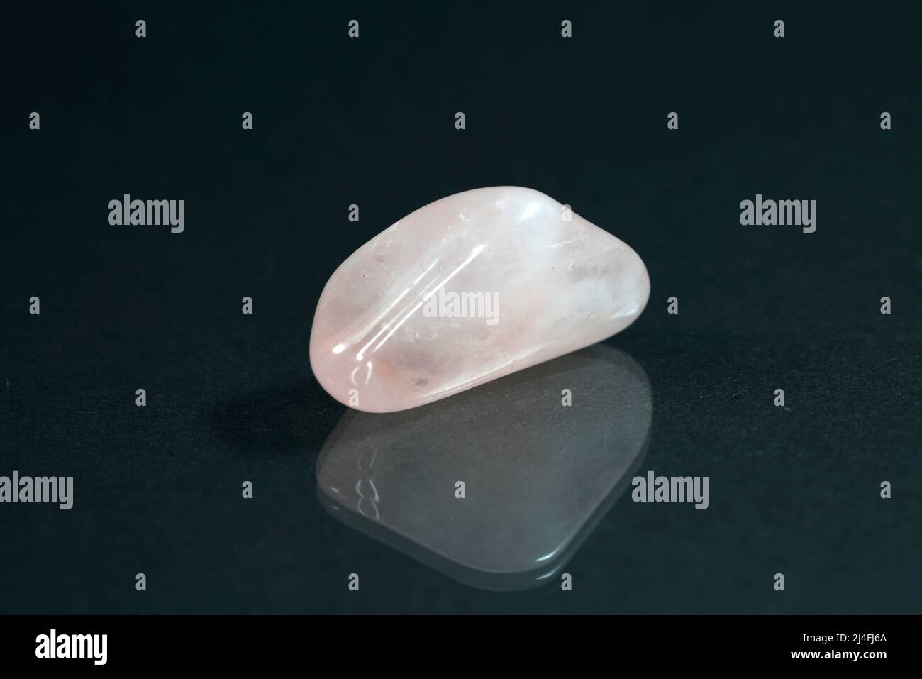 Quartz with mineral inclusions in the studio in front of a background ...