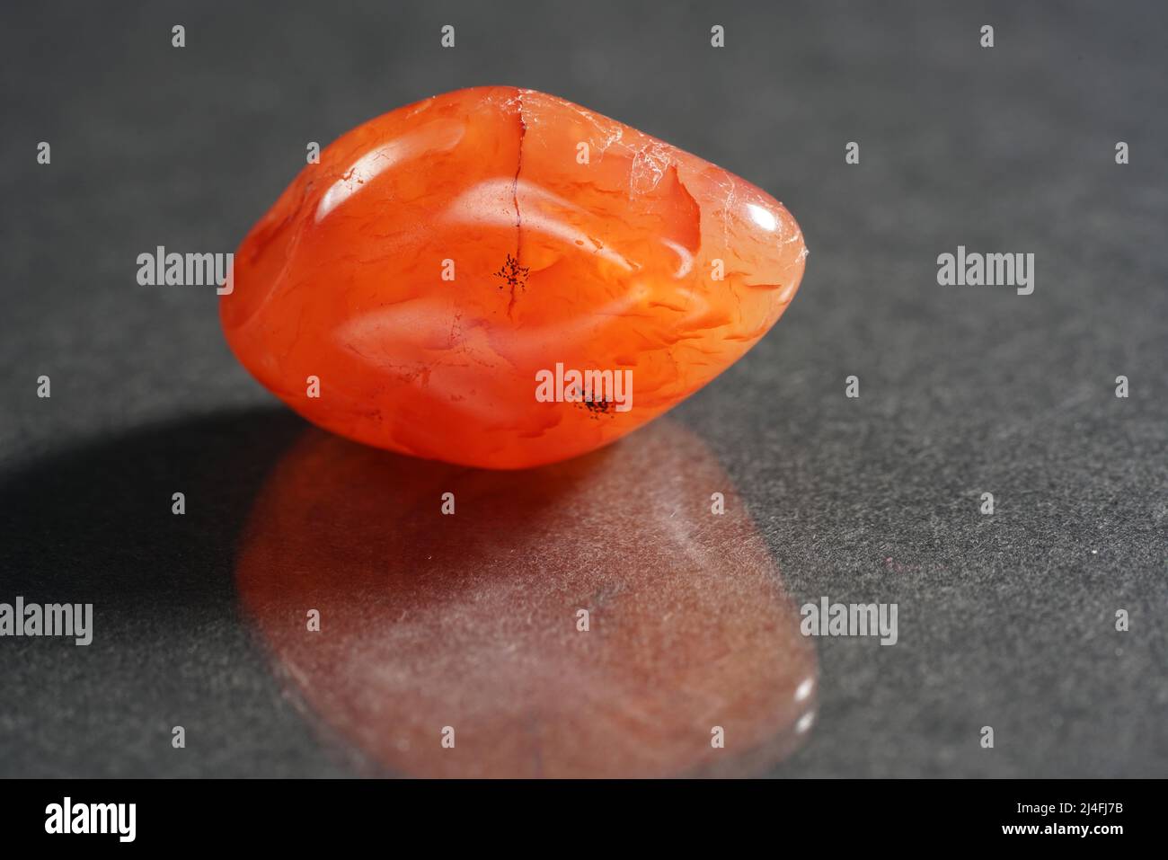 Quartz with mineral inclusions in the studio in front of a background ...