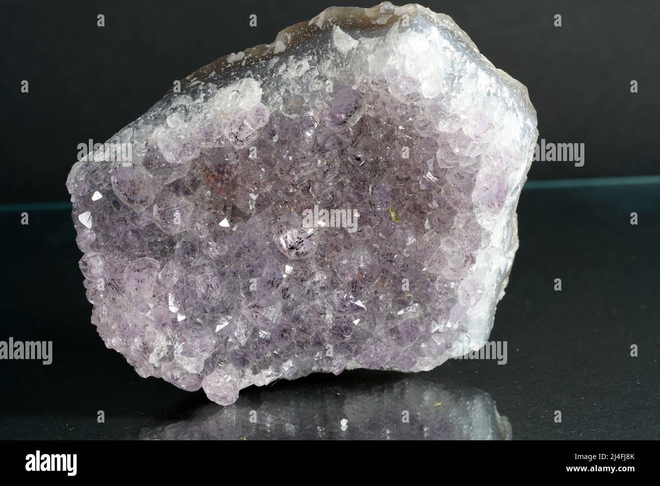 Quartz with mineral inclusions in the studio in front of a background ...