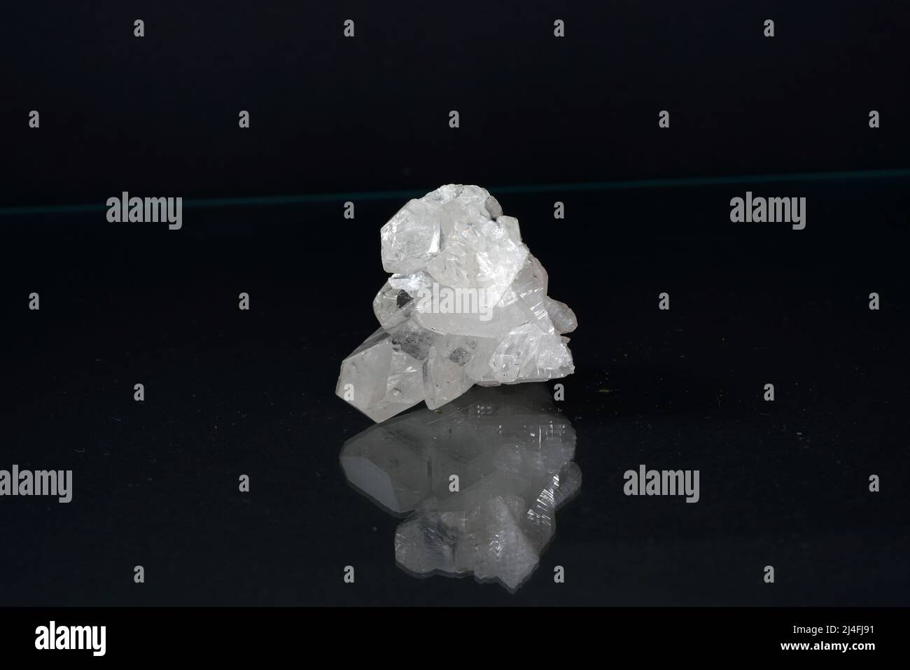 Quartz with mineral inclusions in the studio in front of a background ...