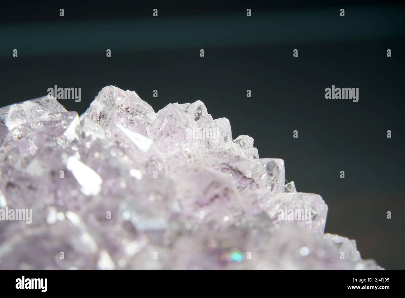 Quartz with mineral inclusions in the studio in front of a background ...