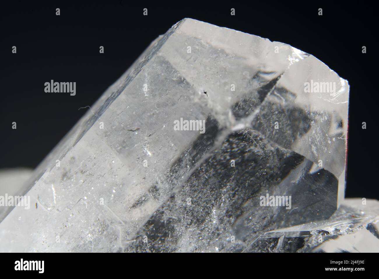 Quartz with mineral inclusions in the studio in front of a background ...