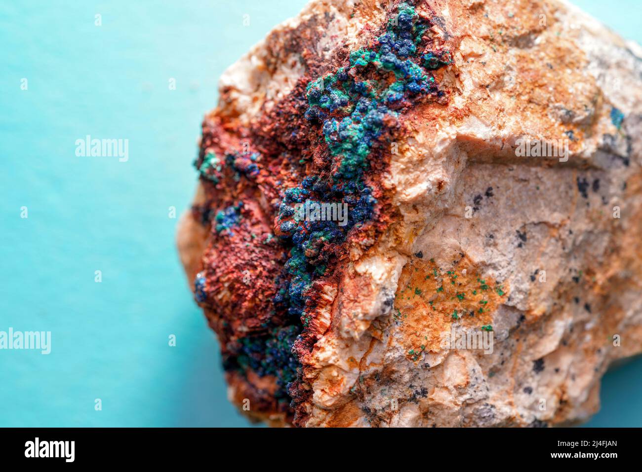 Quartz with mineral inclusions in the studio in front of a background ...