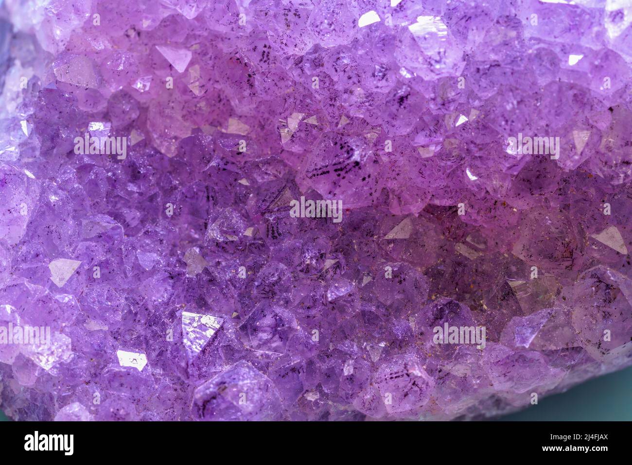 Quartz with mineral inclusions in the studio in front of a background ...