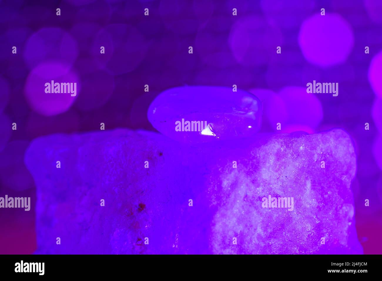 Quartz with mineral inclusions in the studio in front of a background ...