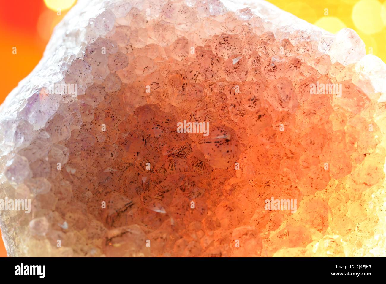 Quartz with mineral inclusions in the studio in front of a background ...