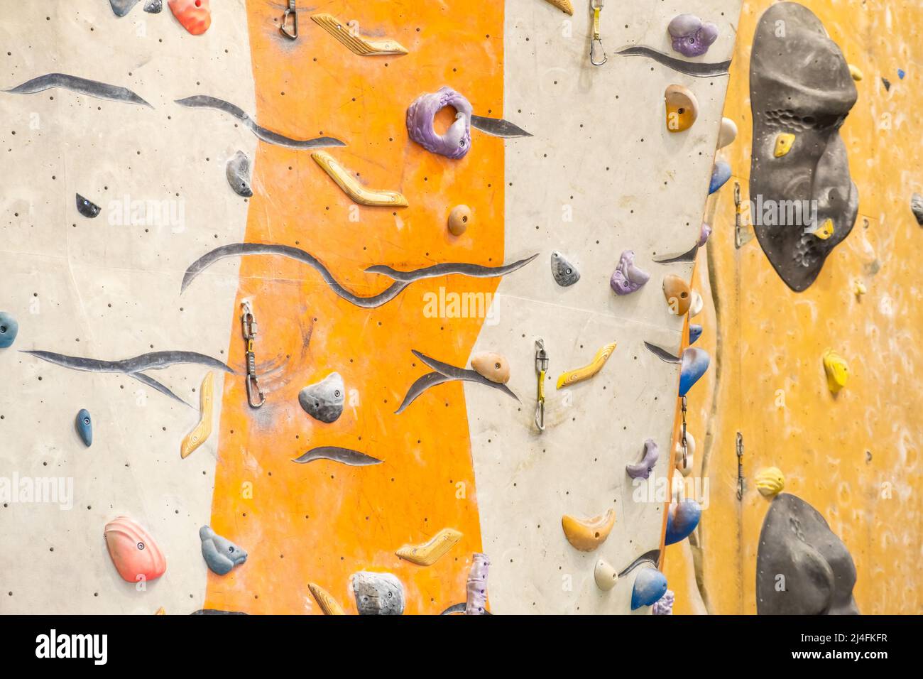 Artificial rock climbing wall with various colored grips Stock Photo ...