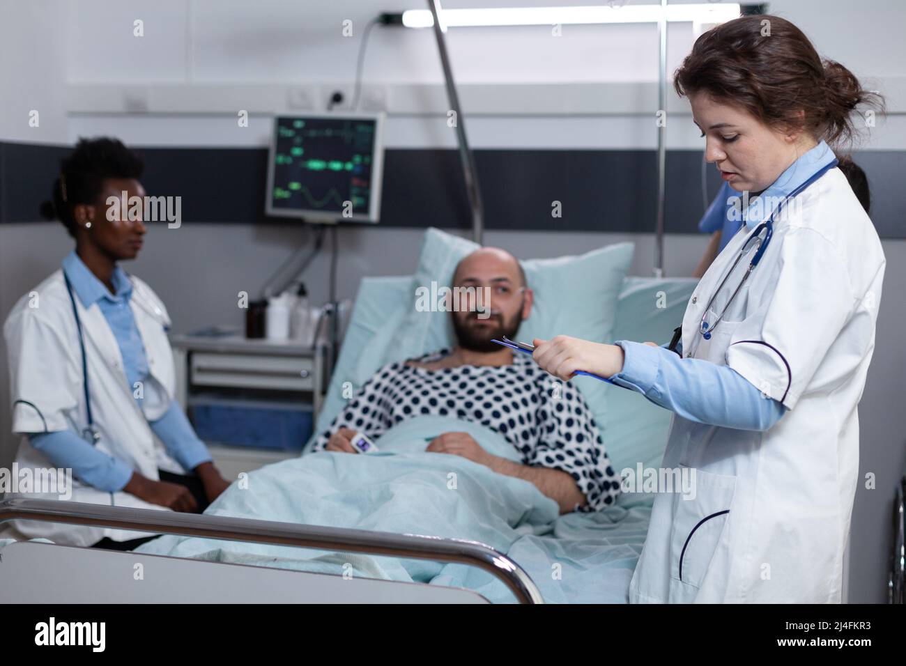 Doctor nurse reading medical chart hi-res stock photography and images ...