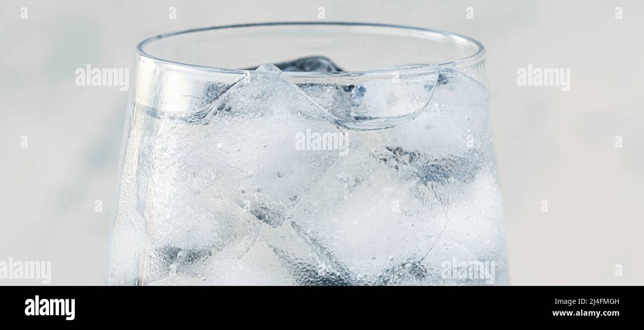 banner with close up glass with ice water and ice cubes on white ...