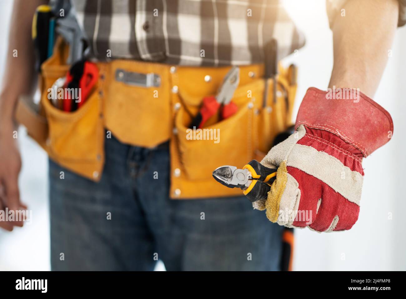 Repairman holding side cutters in hand Stock Photo - Alamy