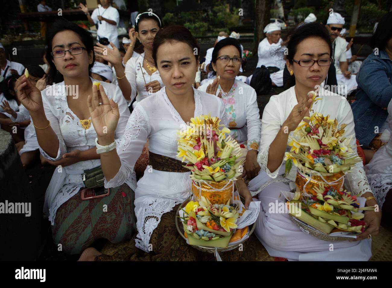 Purifying the spirits: Members of a Balinese family doing a ritual at a ...