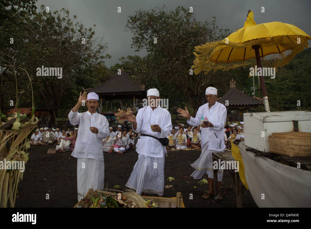 Purifying the spirits: Members of a Balinese family doing a ritual at a ...