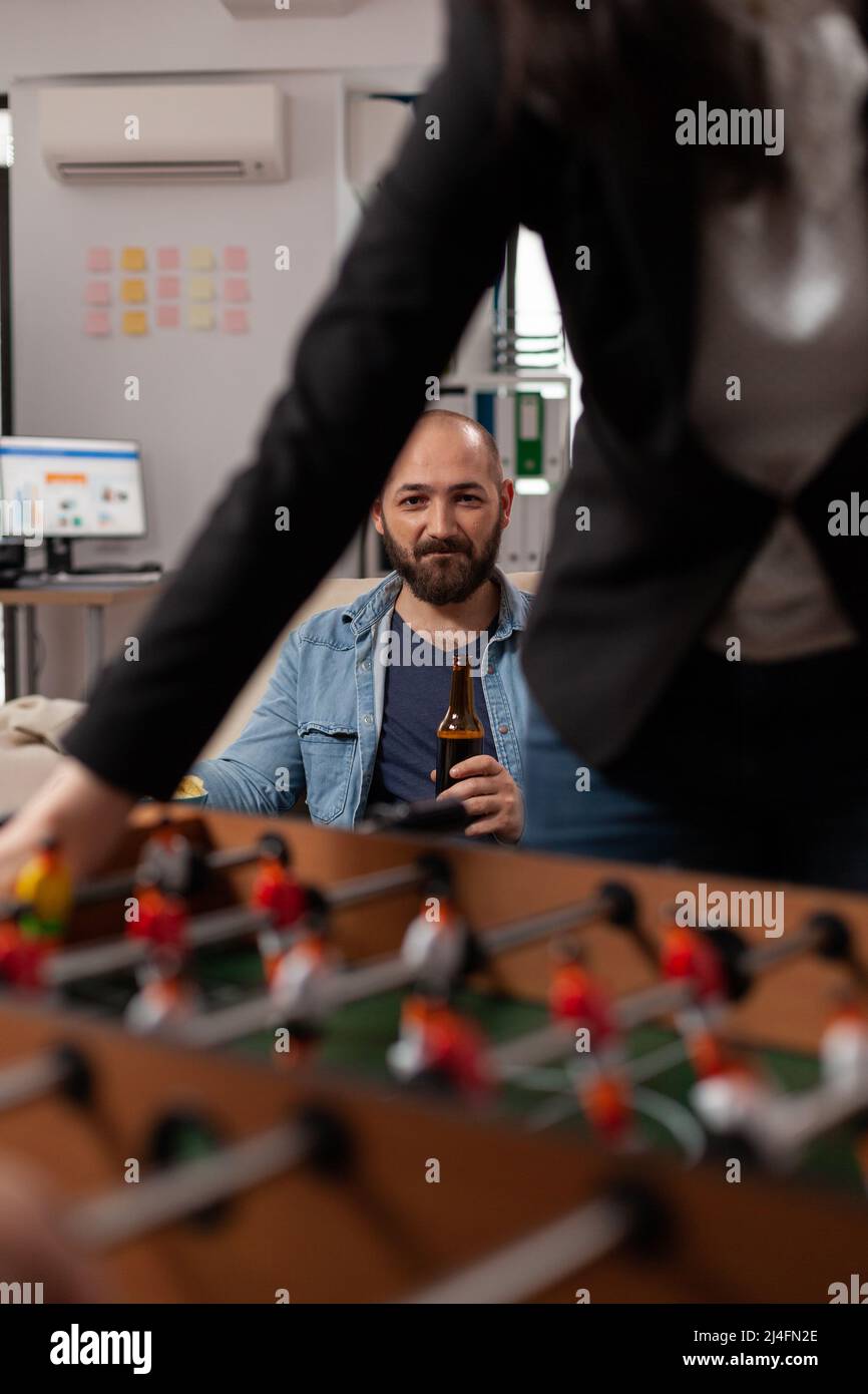 Portrait of business man drinking beer from bottle at office party ...