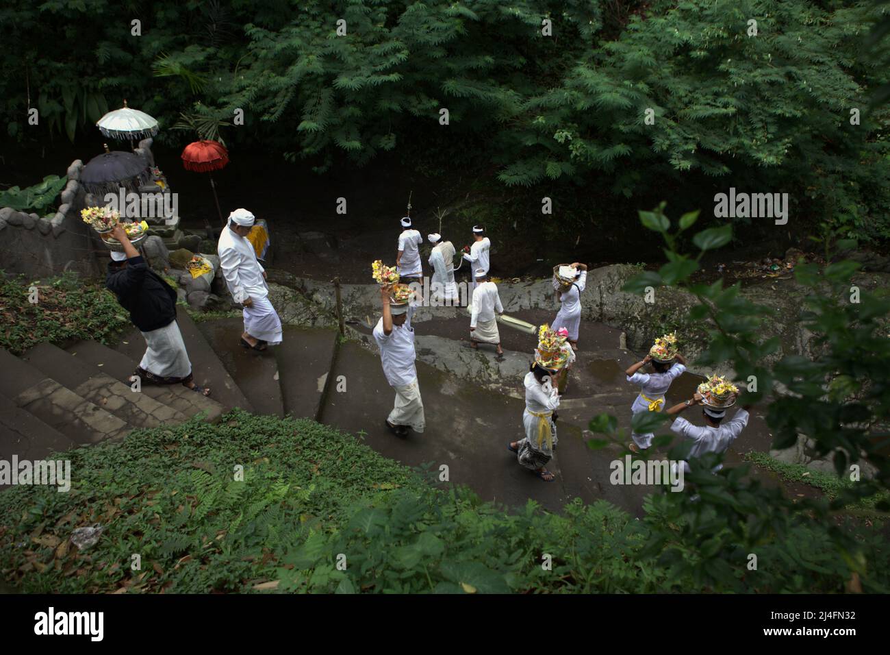 Purifying the spirits: Members of a Balinese family march during a ...