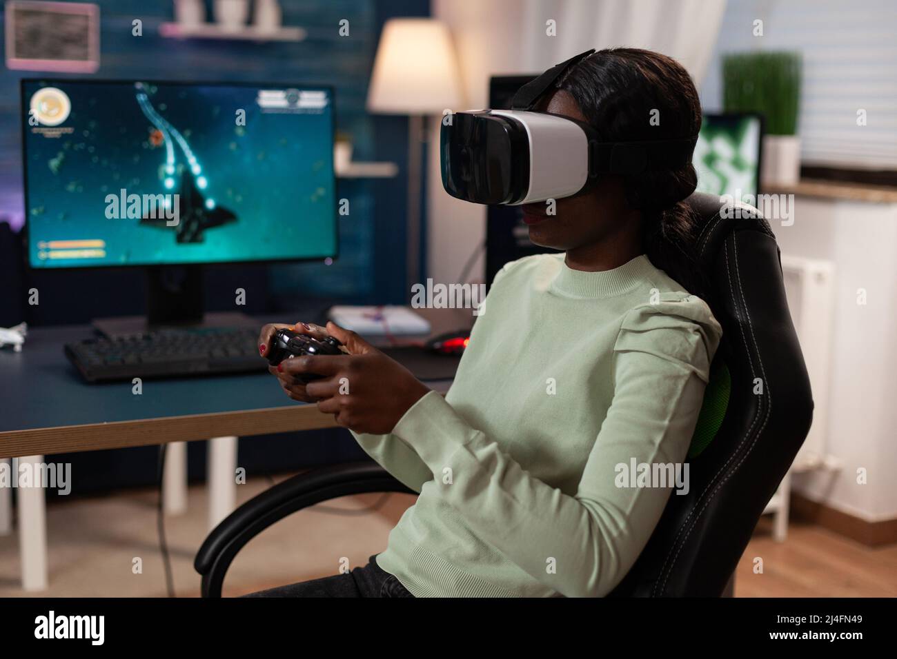 Pro gamer woman wearing virtual reality headset holding gaming joystick ...