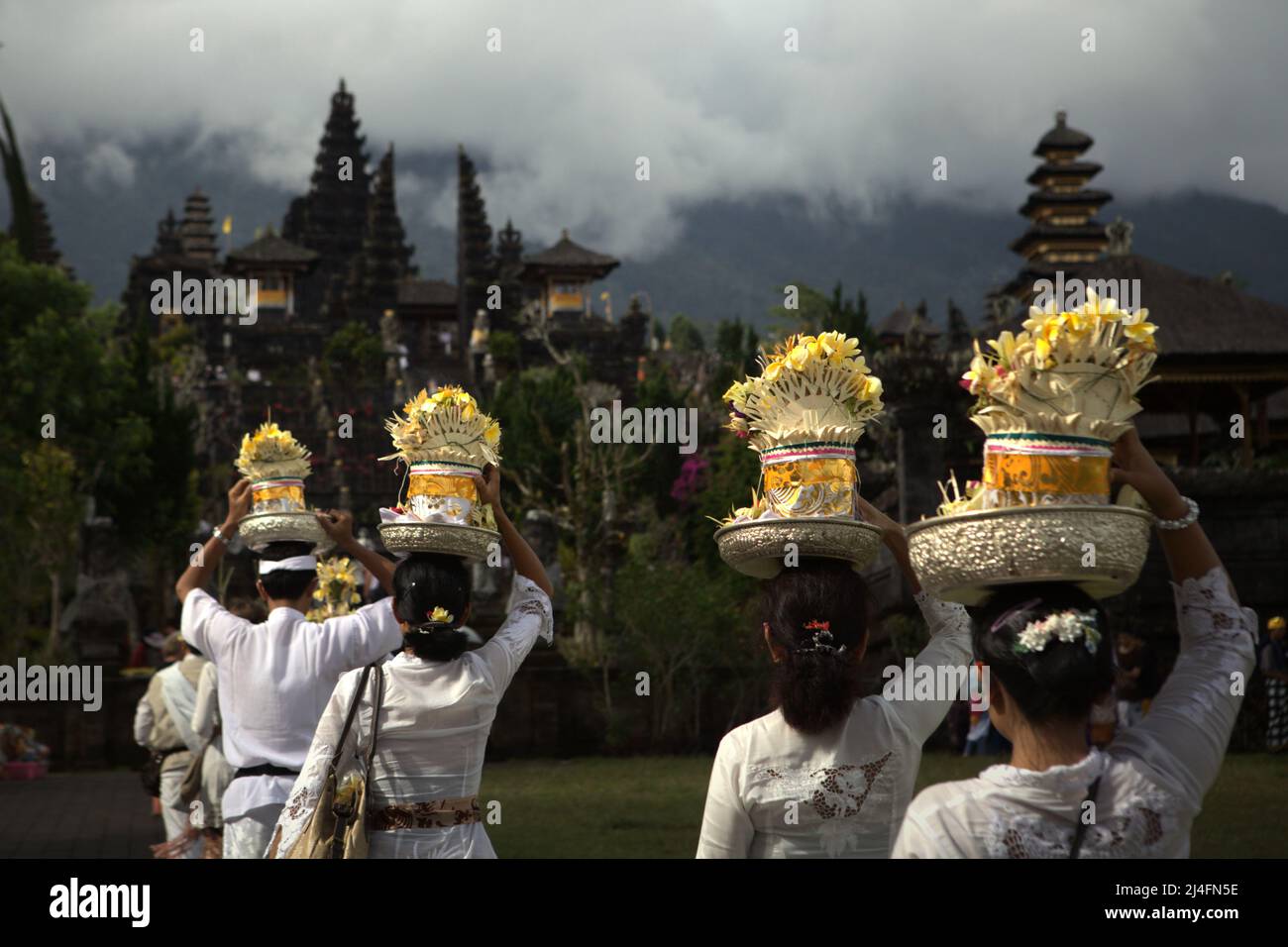 Purifying the spirits: Members of a Balinese family march during a ...