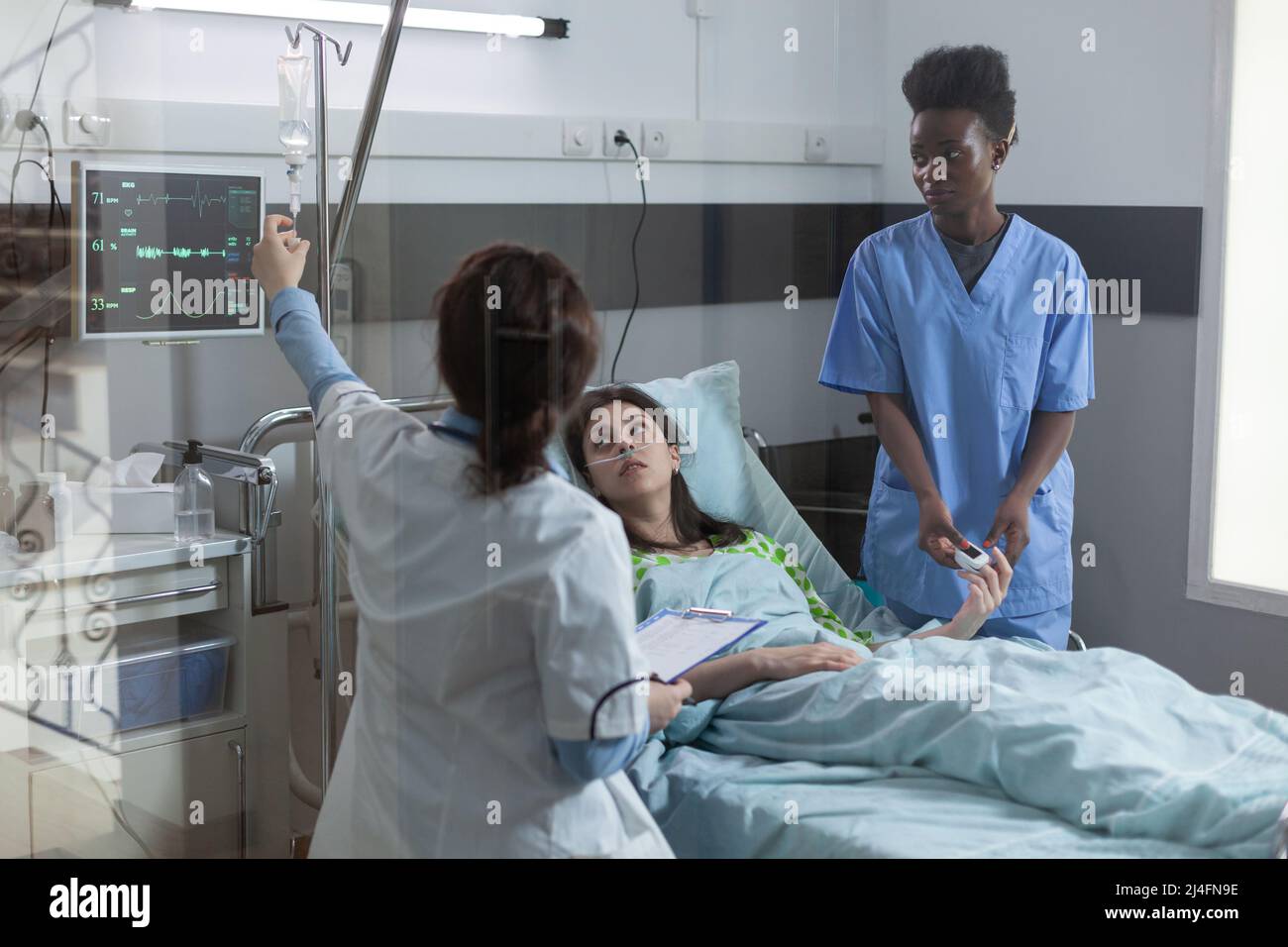 Doctor setting up central line catether with iv drip medication to ...