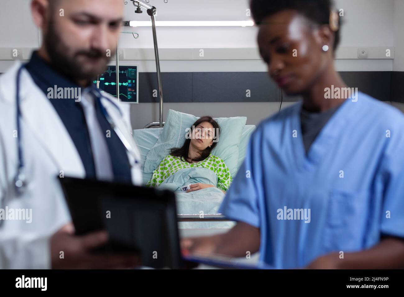Patient on hospital bed feeling ill waiting for medic and nurse to read ...
