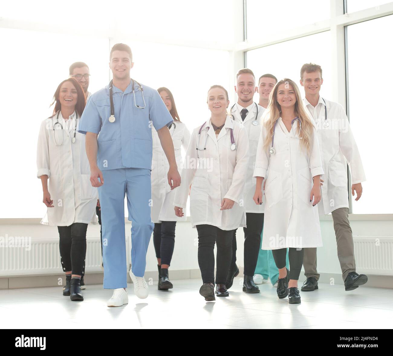 Doctor walking down corridor Cut Out Stock Images & Pictures - Alamy
