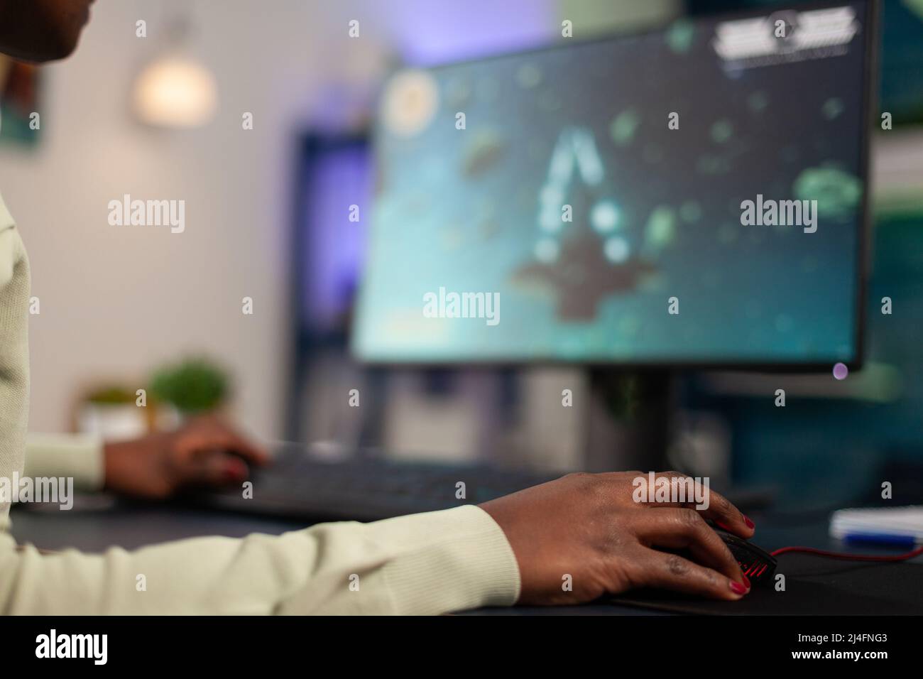 Close-up of professional successful gamer holding hand on computer ...