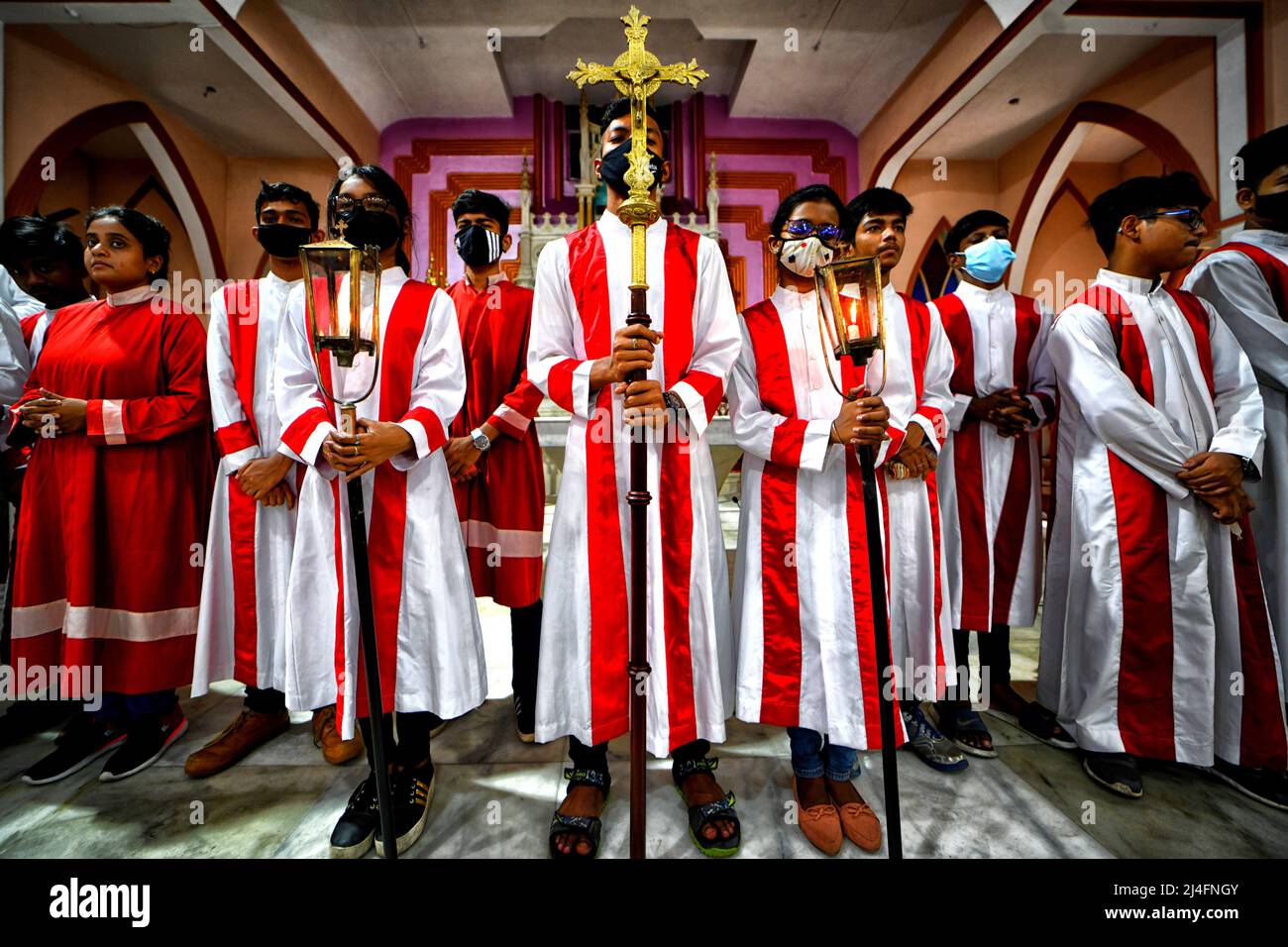 Christian youths and devotees seen carrying a cross as they take part in the religious ...